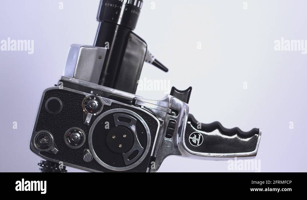 Vintage Bolex 8mm film camera rotating against white background ...