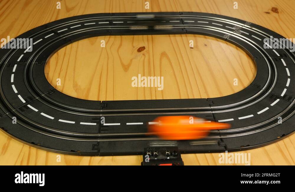 Toy car racing track with orange and black formula 1 cars Stock Video ...