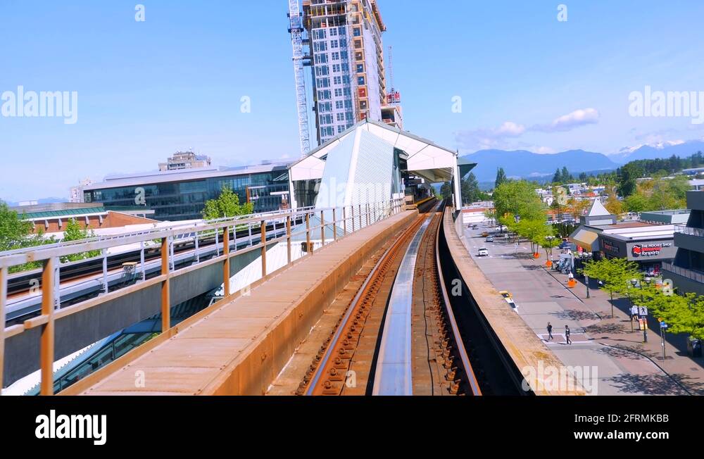 4K Above Ground Train Arrives at Station Platform Stock Video Footage ...