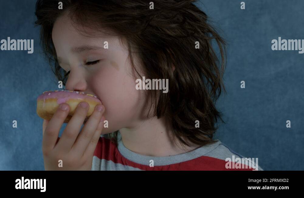 A boy child kid eating a donut doughnut donuts Stock Videos & Footage ...