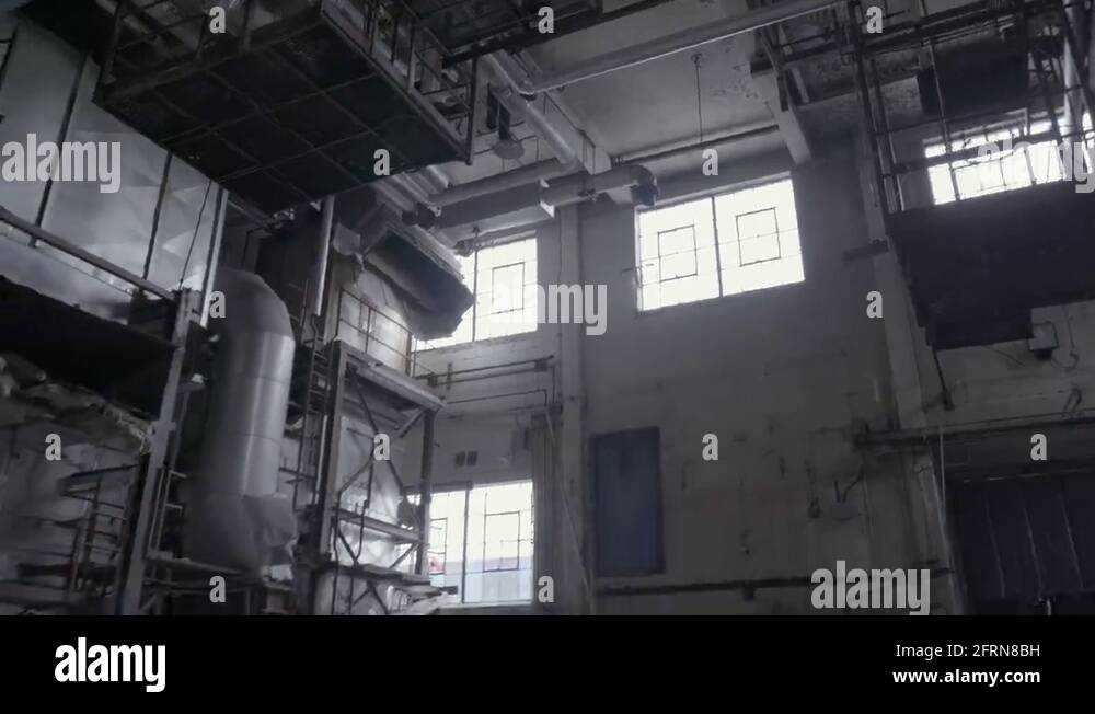 A pan, tilt shot from the metal catwalk to the concrete floor of an ...