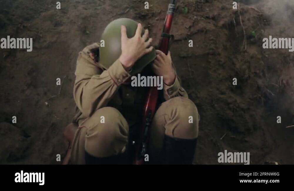 Scared Soviet soldier sits in the trenches during the battle. World War ...