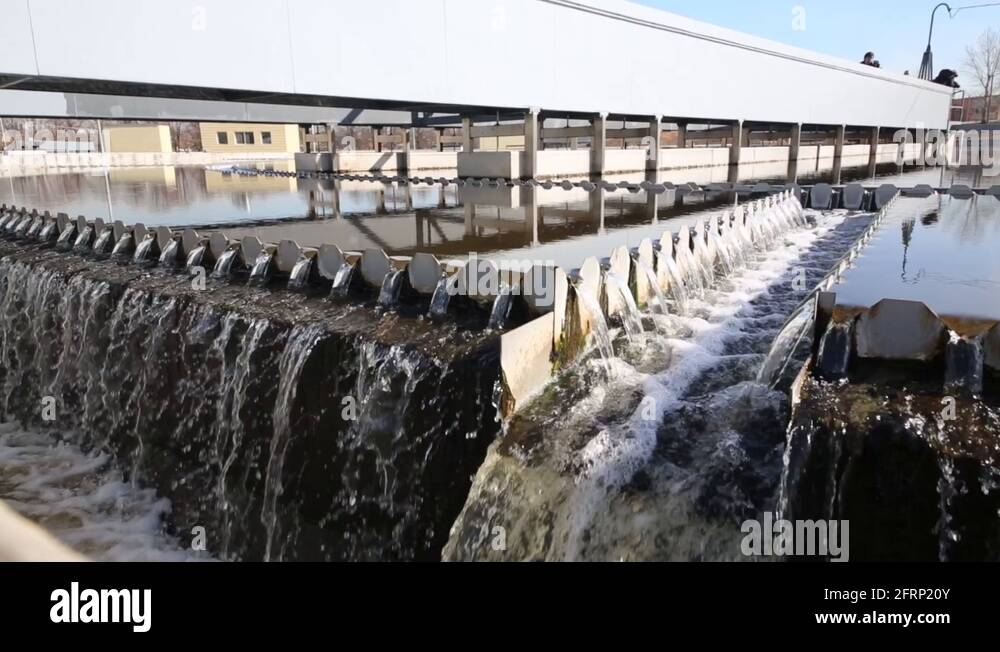 Wastewater flows through chute of settler in wastewater treatment ...