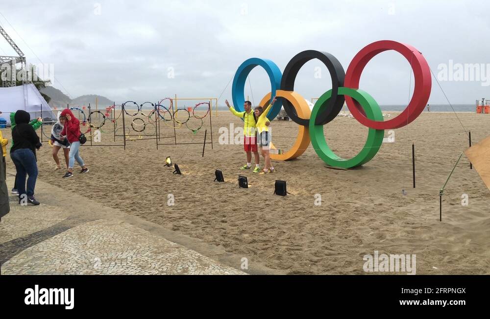 People posing in front of Olympic Rings at Copacabana beach in Rio 4k ...