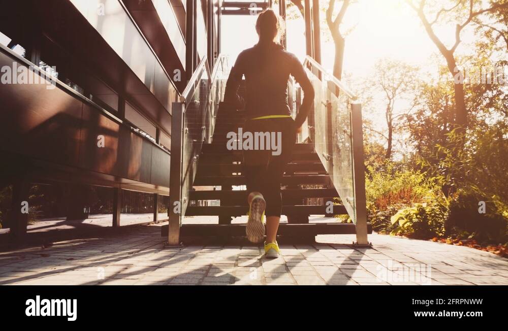 Runner Woman Jogging up Stairs, Lens Flare. 4K STABILIZED. Healthy ...