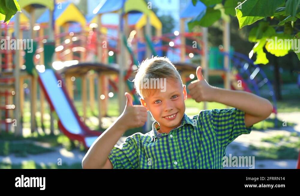 Boy poses for camera with thumbs up as sign of like Stock Video Footage ...