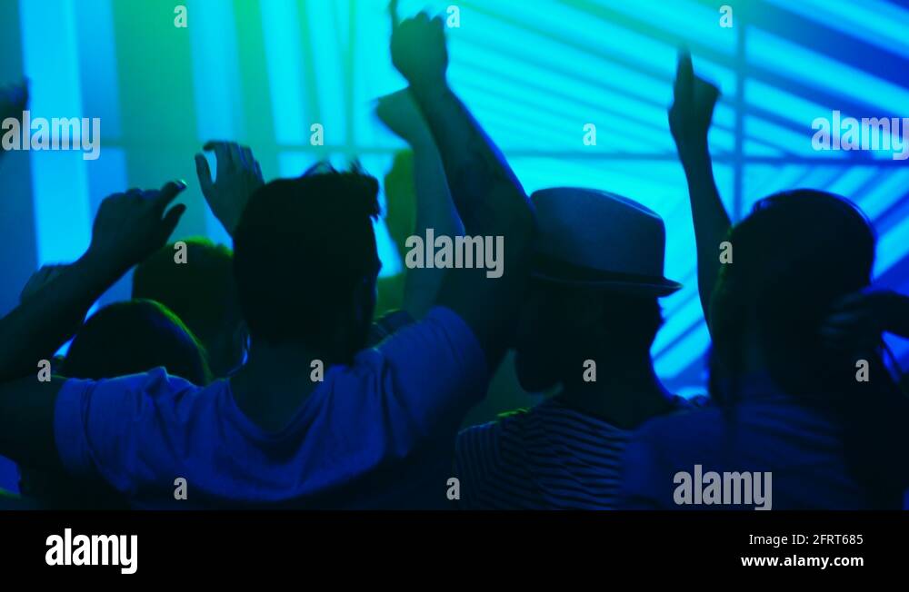 DJ Playing Music in Nightclub, People Dancing, Having Fun and Raising ...