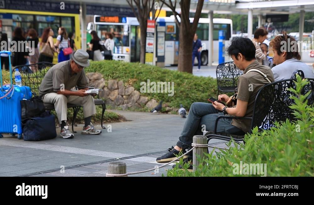 People sitting on bench using Stock Videos & Footage - HD and 4K Video ...
