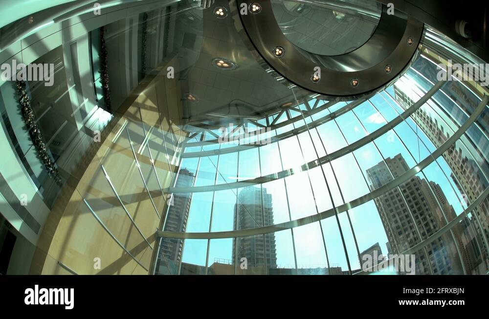 Ascending day city glass elevator in modern skyscraper building ...