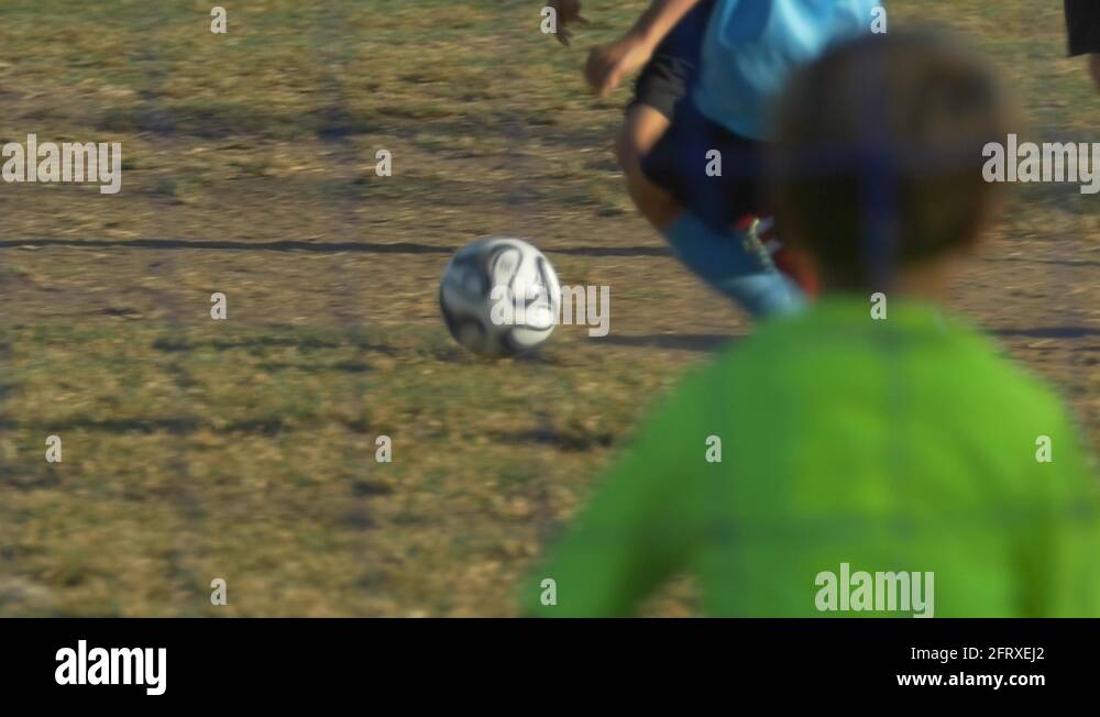 A boy falls while playing youth soccer football Stock Video Footage - Alamy