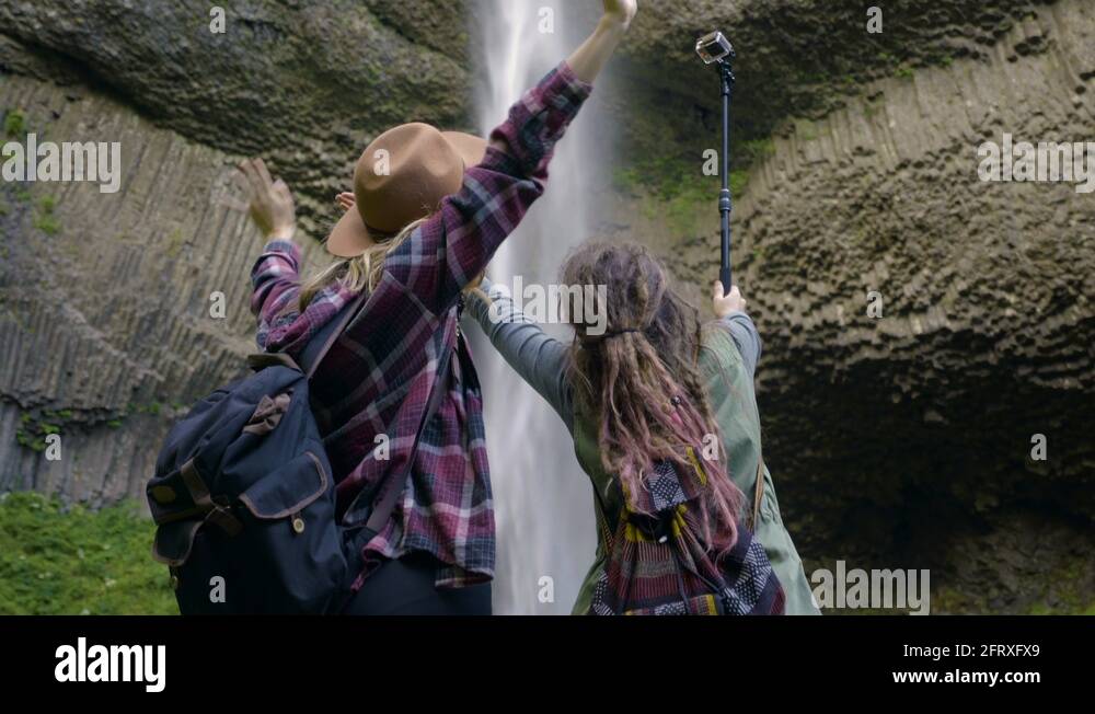 Hikers Use A Gopro And Pose For Selfies By A Waterfall Stock Video ...