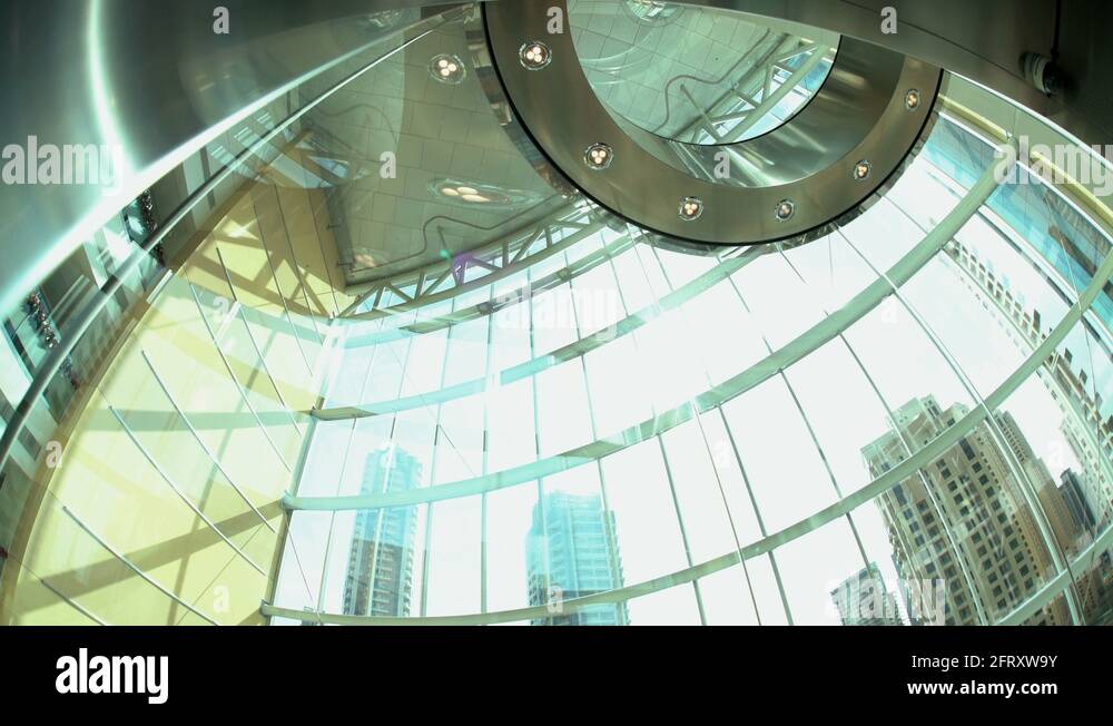 Descending day city glass elevator in modern skyscraper building in the ...
