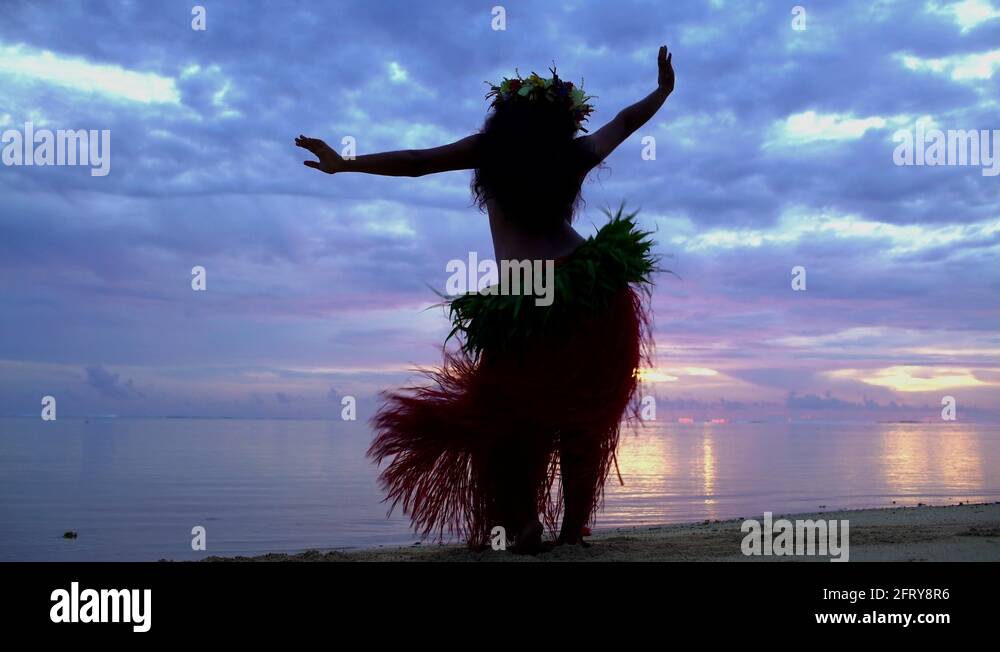 Polynesian girl in traditional grass skirts and flower headdress ...
