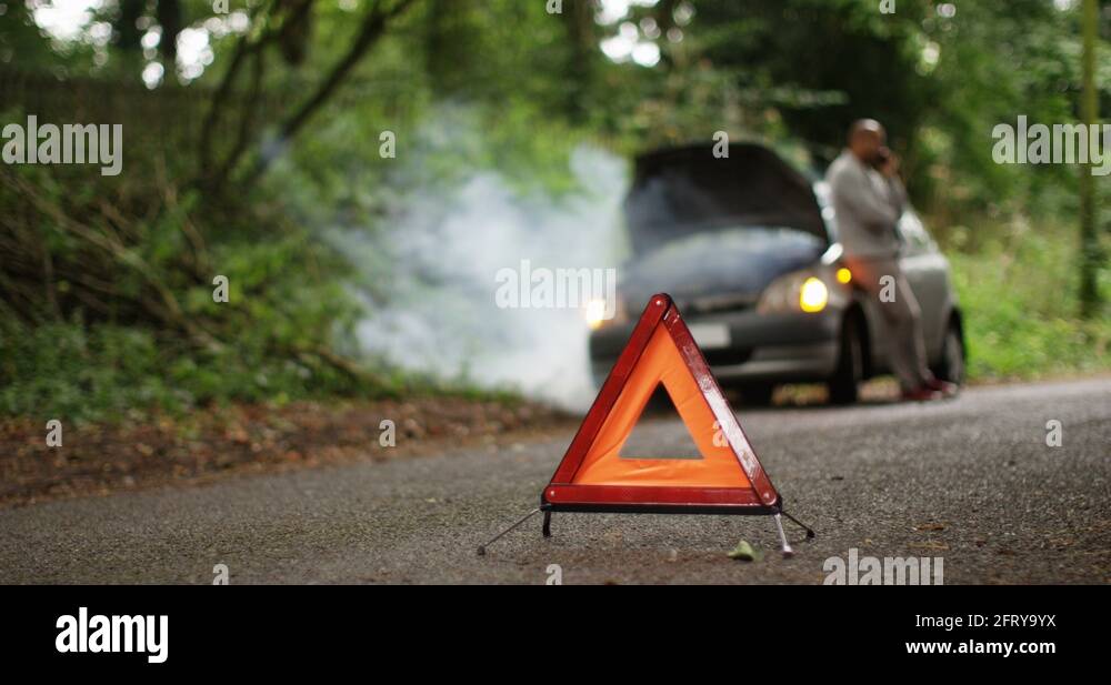 4K Stranded man with broken down car phoning for assistance on country ...
