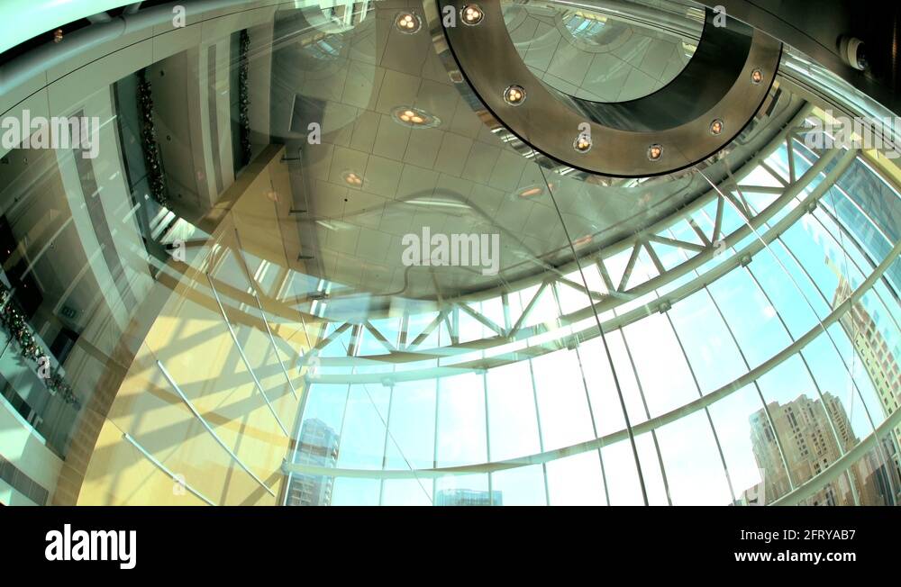 Ascending day city glass elevator in modern skyscraper building ...