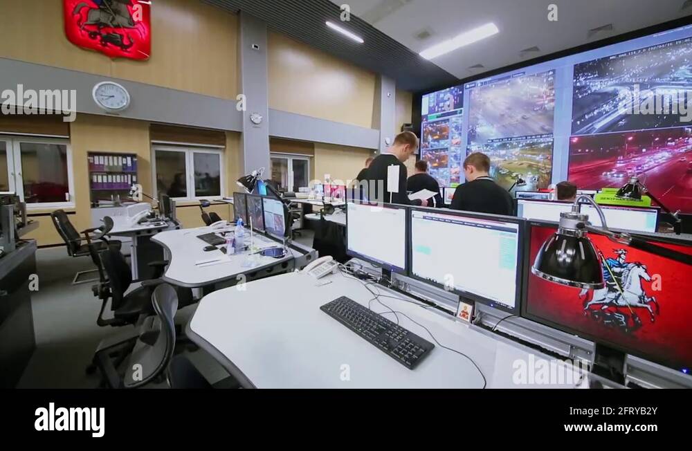 People work in operations room with many displays in data center Stock ...