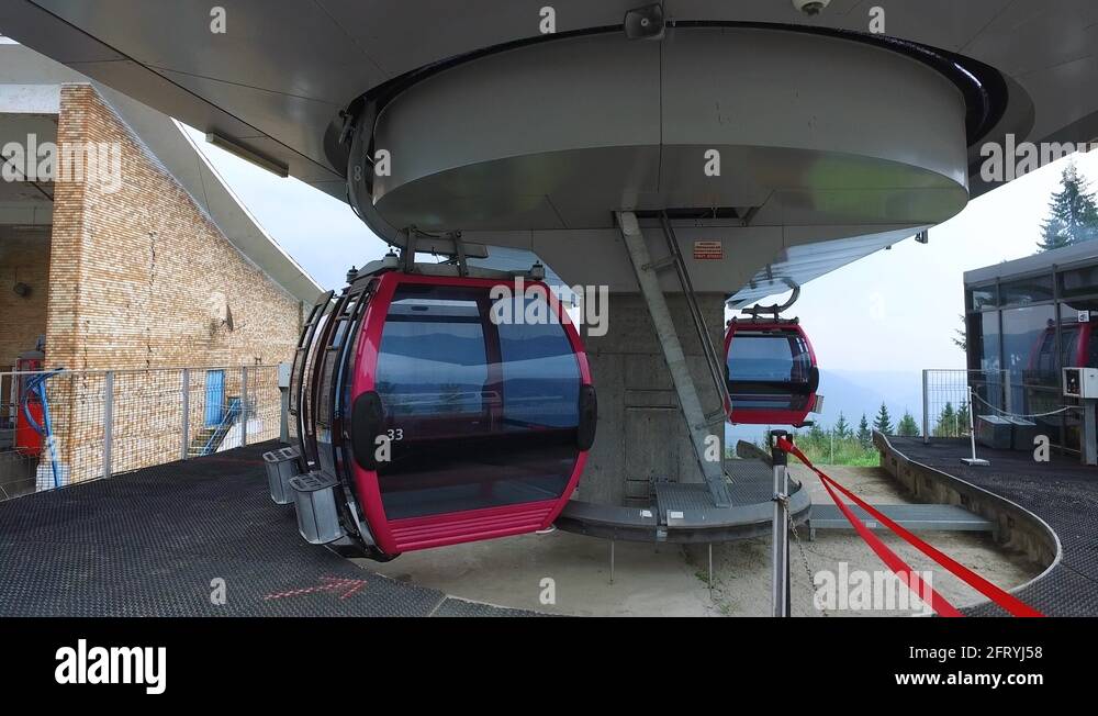Modern small empty cable car, gondola pulling slowly in the ground ...