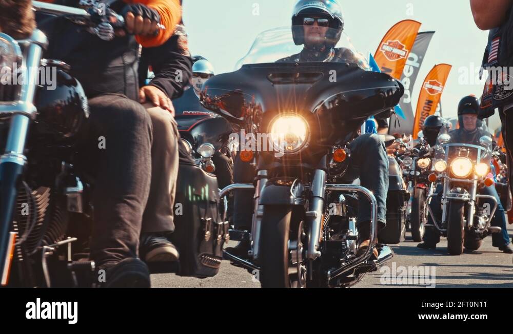 Female motorcyclist makes a peace sign with her hand at a huge biker ...