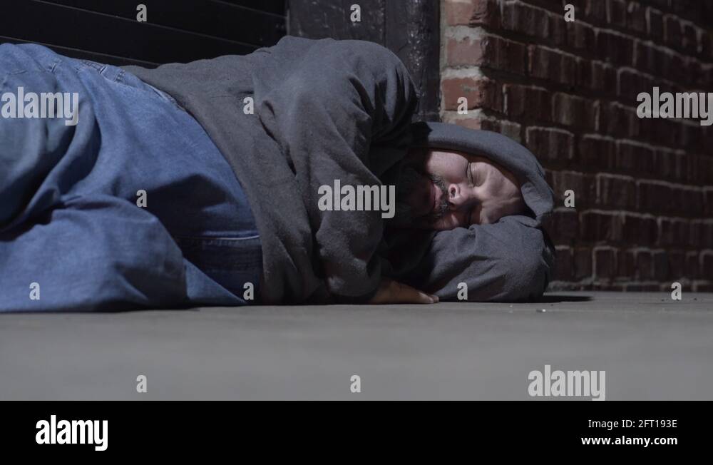 Homeless man sleeping in alley of side street at night 4k Stock Video ...