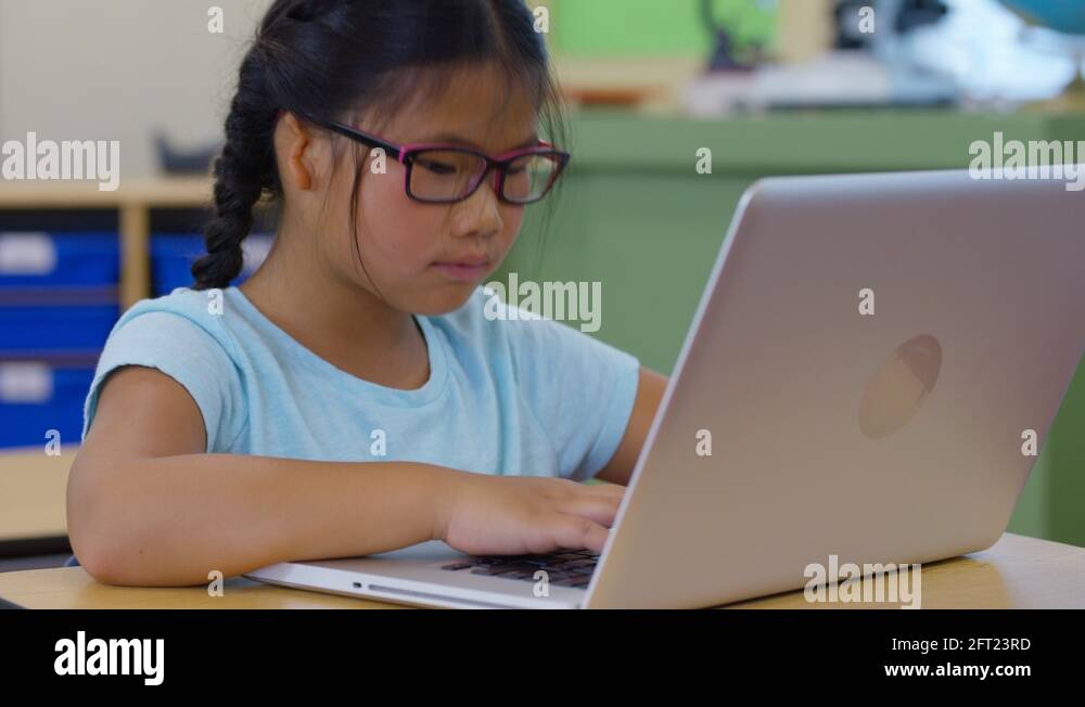 Girl in school classroom working on laptop computer Stock Video Footage ...