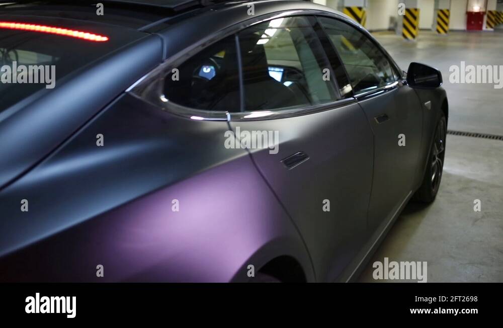 Tesla S car goes backwards woman sits at wheel in parking Stock Video ...
