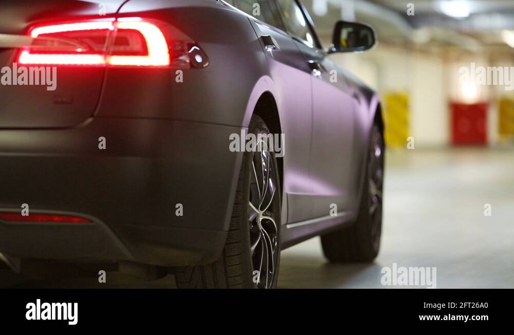 Tesla S car goes backwards and rear lights flash in parking Stock Video ...