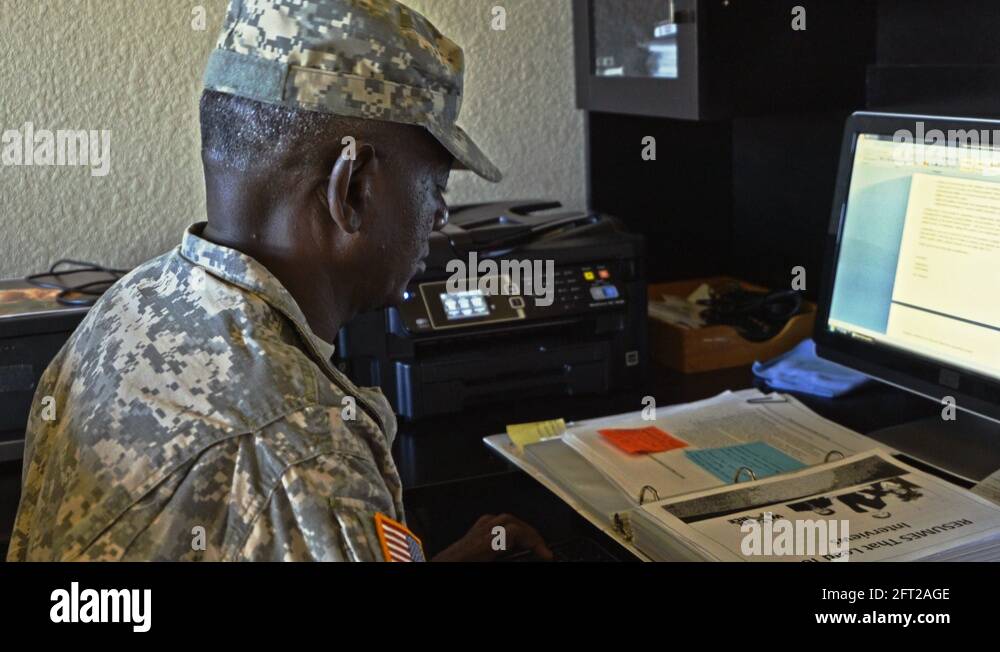 Black man in military uniform working on computer in office Stock Video ...