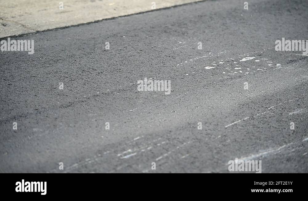 Asphalt paving with a steel wheel roller. Steam coming out from asphalt ...