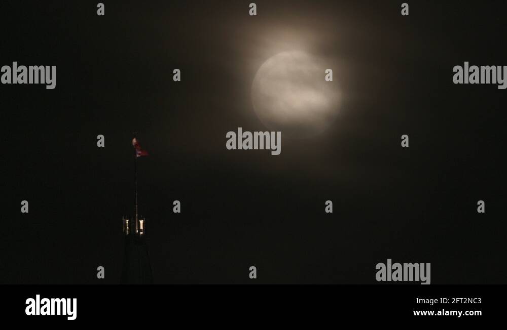 Full Moon next to Canadian flag waving on the Peace Tower at Parliament ...
