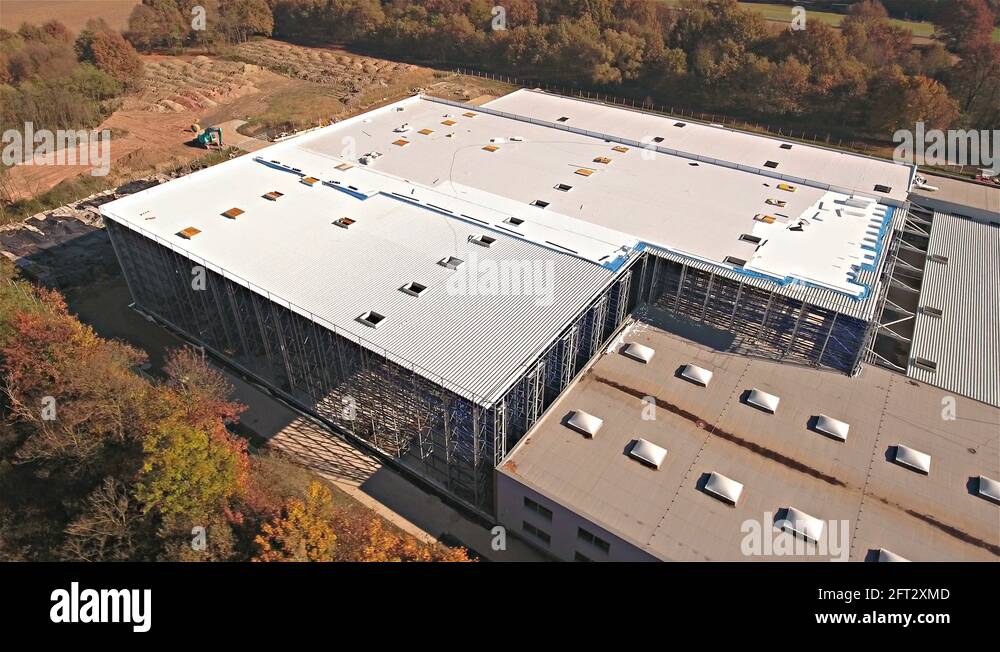 Flying around a new build warehouse building in bird's eye view 4K ...
