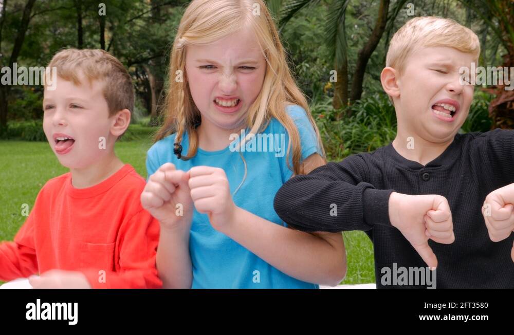 Three young children say yuck and hold their noses in disgust Stock ...