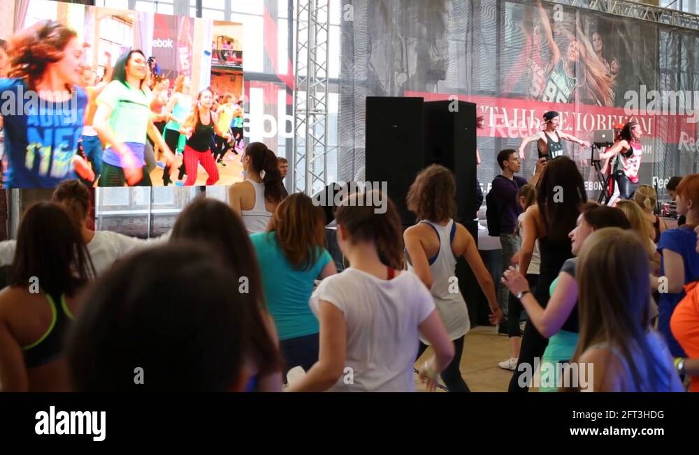 Women dancing and clapping hands with Valeria Lenovitskaya on fitness ...