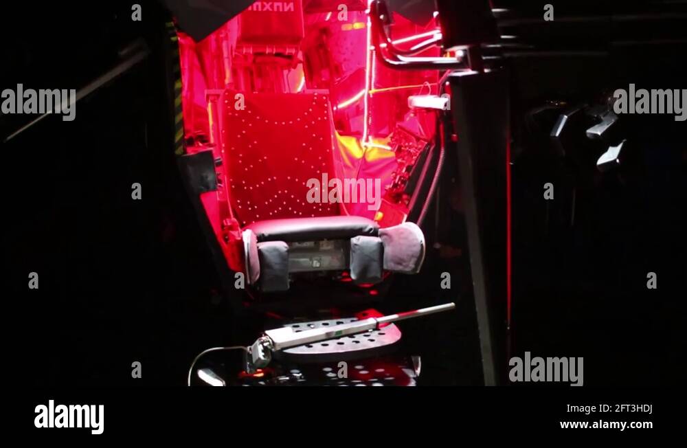 Armchair inside big robot in red light and with head on Bronebot Stock ...