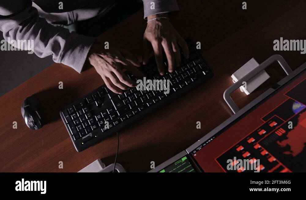 Hacker hands cracking code using computers in dark room Stock Video ...