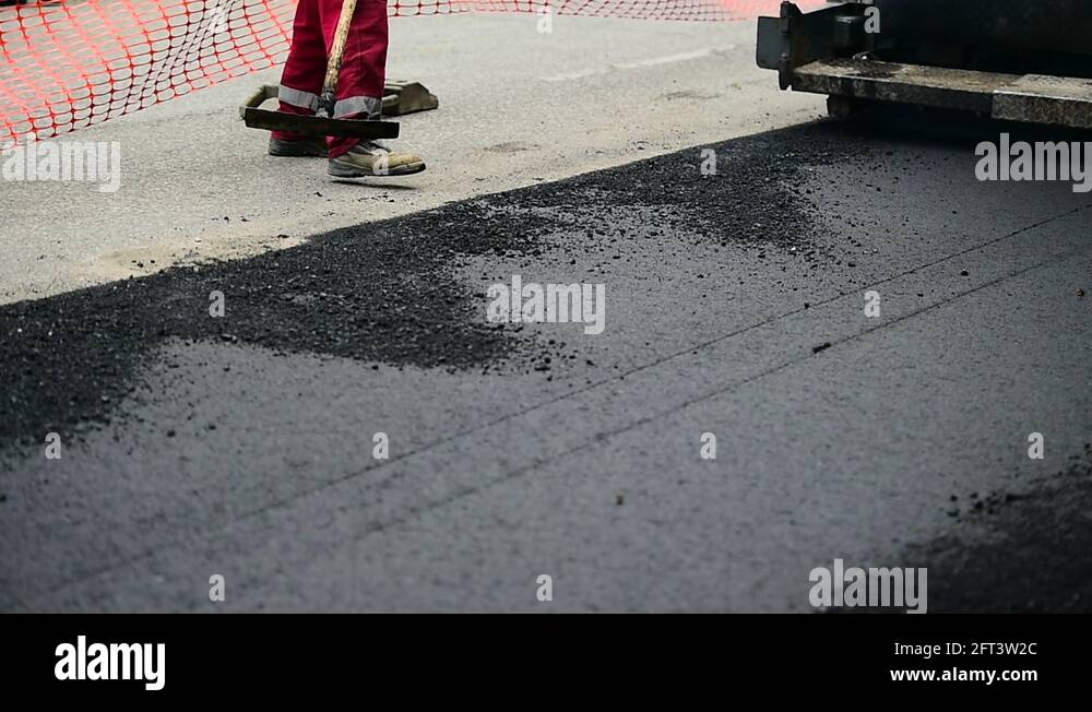 Asphalt paving with a steel wheel roller. Steam coming out from asphalt ...
