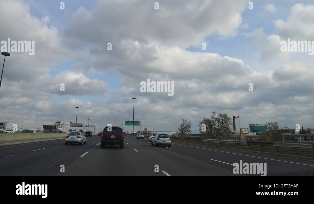Driving into the city of Toronto on the Gardiner expressway highway ...