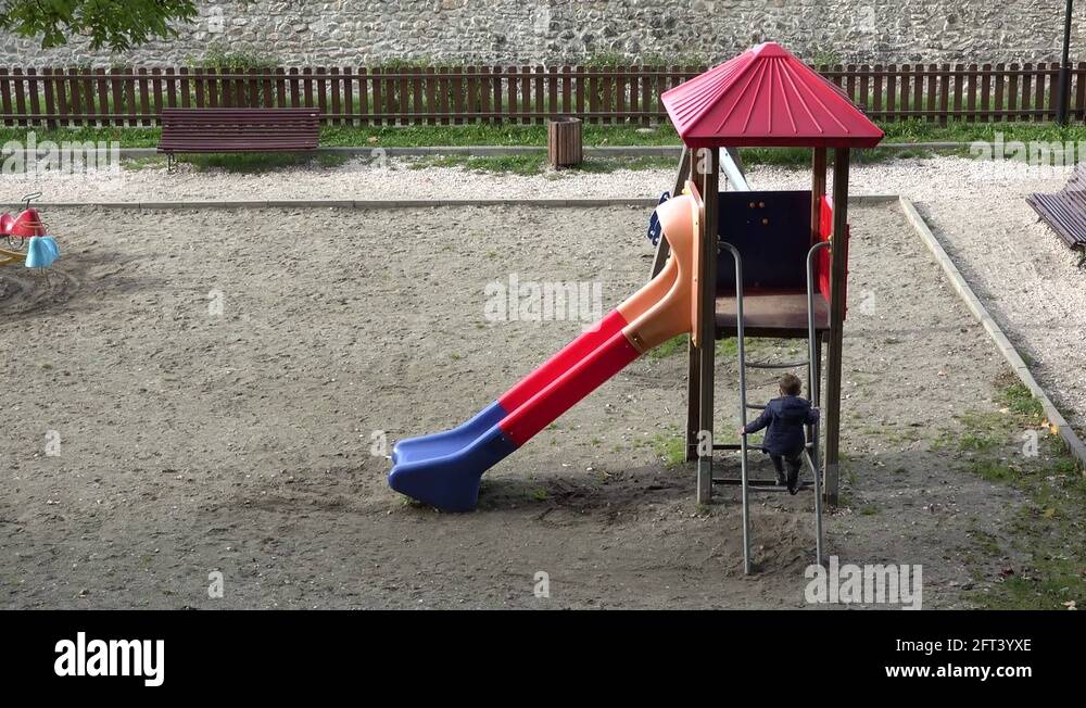 Little child going up on slide stirs, playground up view Stock Video ...