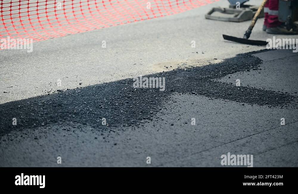 Asphalt paving with a steel wheel roller. Steam coming out from asphalt ...