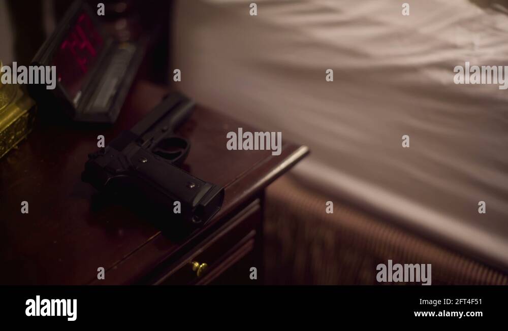 gun on side of dresser bedside pistol Stock Video Footage - Alamy