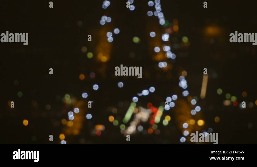 Eiffel Tower aerial at night with lighthouse light above Paris Stock ...