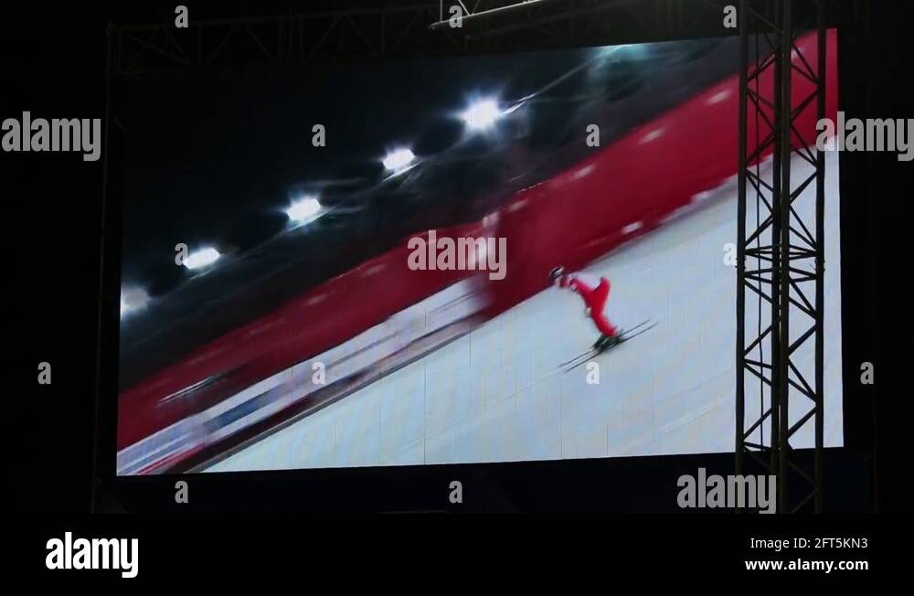 Sportsman jumping big ramp on screen on World Cup Freestyle Stock Video ...