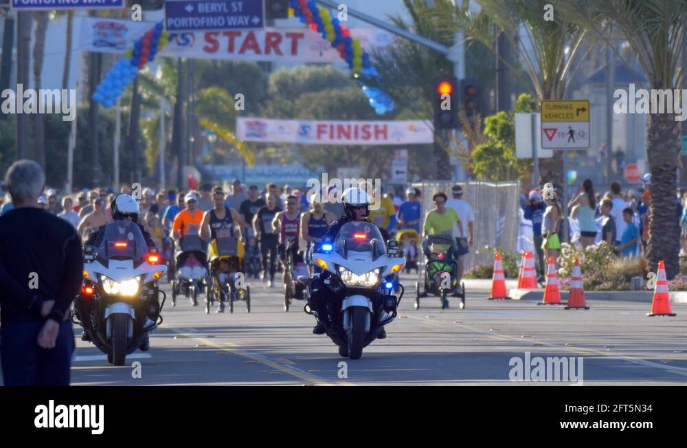 A crowd of people running at the start of a 10K race Stock Video ...