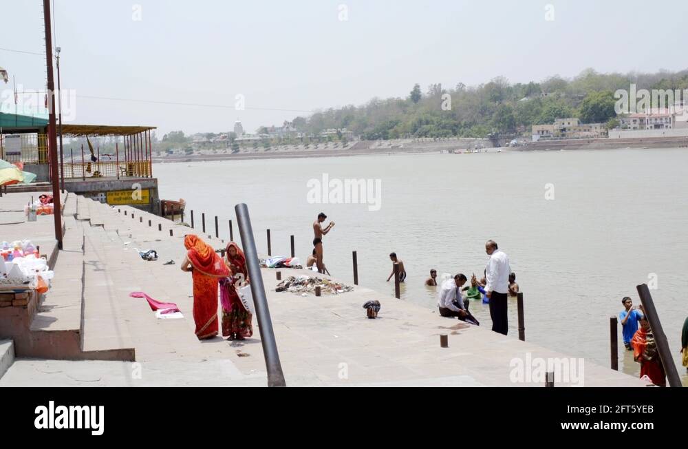 People bathe and shower at holy Ganges river, Ram Jhula Ghat, Rishikesh ...