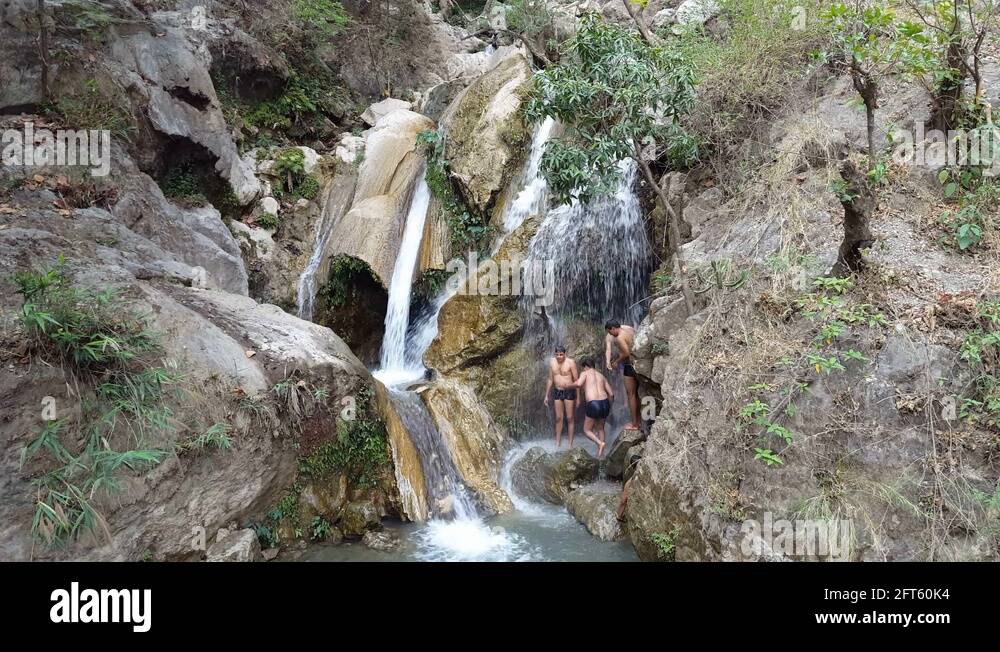 Indian men bathe in beautiful lush green nature waterfall, Rishikesh ...