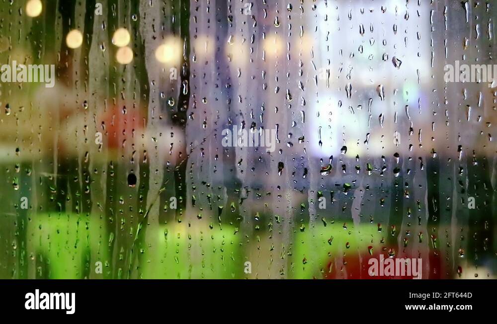 Water drops sliding down on store window glass Stock Video Footage - Alamy