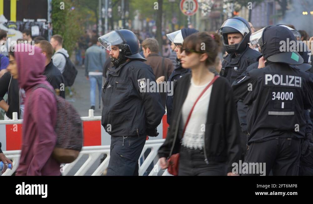Riot police officers, crowd of people in the street, 1st of May, Berlin ...