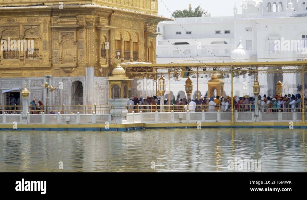 Crowd of people, sikh pilgrimage worship, enter Golden Temple, Amritsar ...