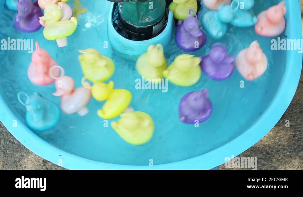 A lot of colorful rubber ducks float in the water flow Stock Video ...
