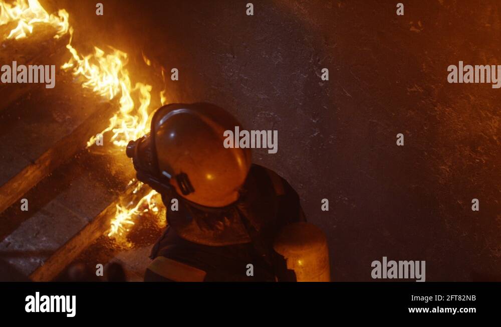 Brave Fireman Goes Up Burning Stairs. Building is on Fire. Flame and ...