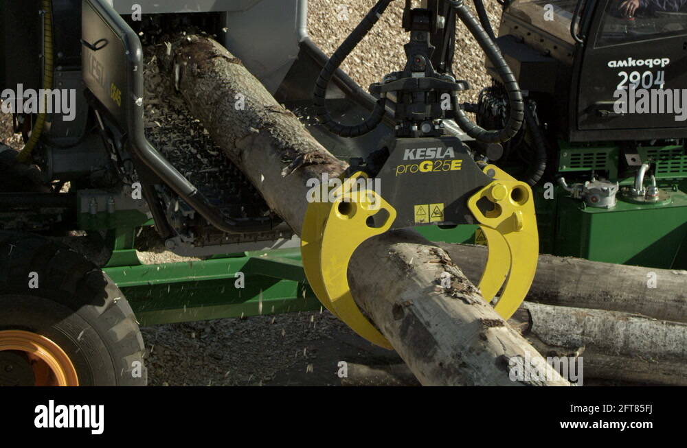 Woodchoper's grooved rollers drag the timber making wood chips Stock ...